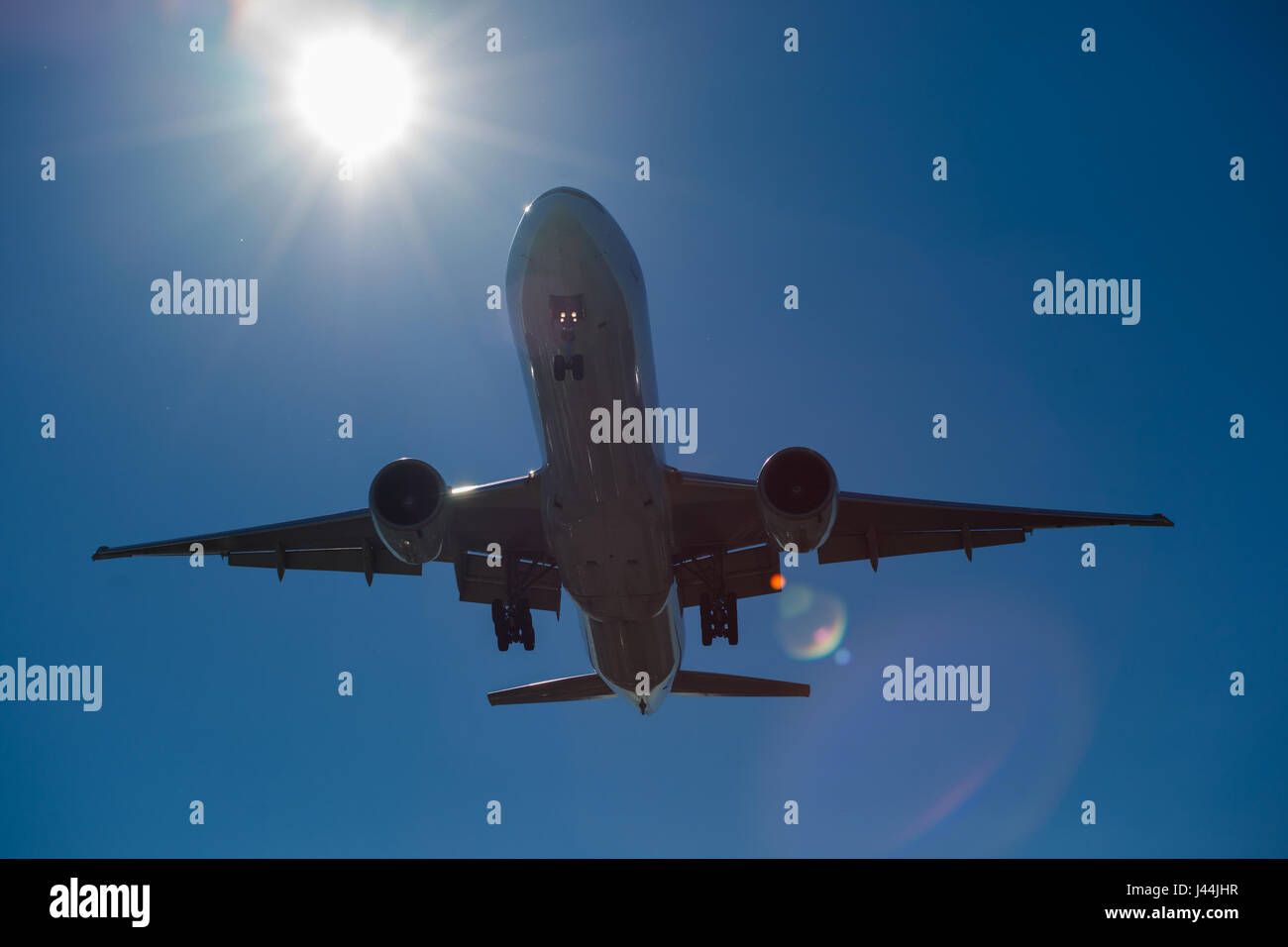 Jet liner landing at Toronto Pearson Airport with sun in the background ...
