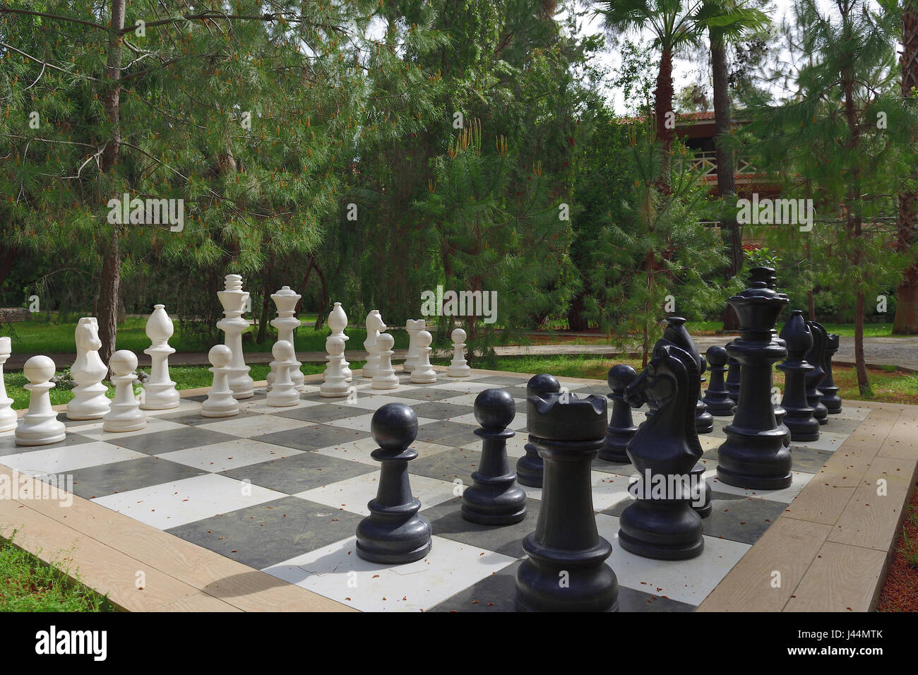 Large chess set outdoors on lawn Stock Photo - Alamy