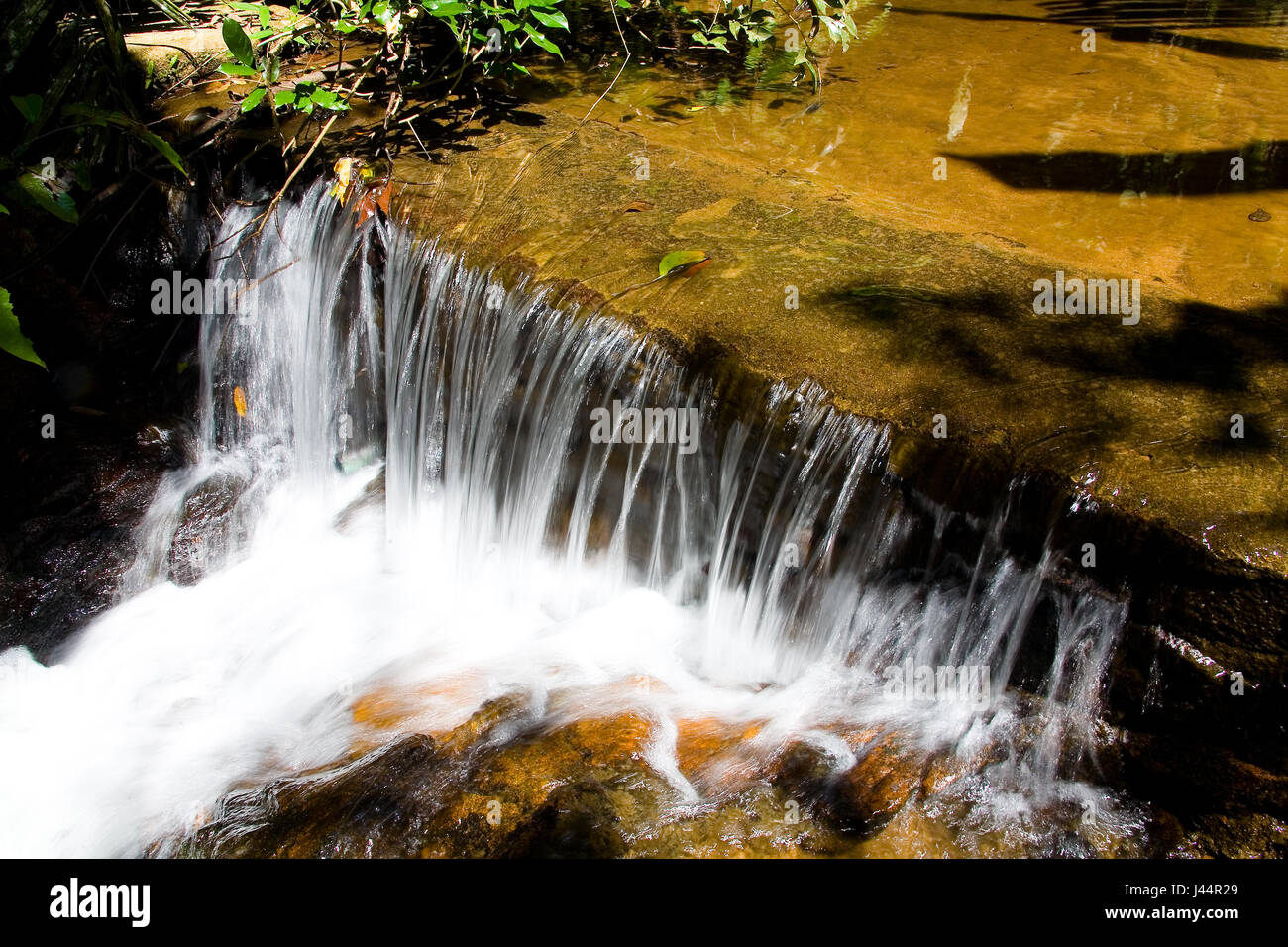 Nature. A small tropical waterfall with clear water Stock Photo - Alamy