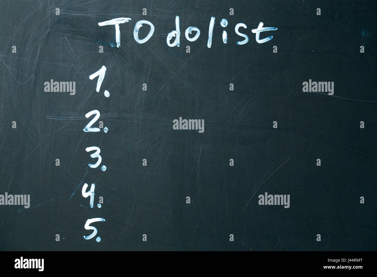 inscription do it list drawn with chalk on a school blackboard dark ...