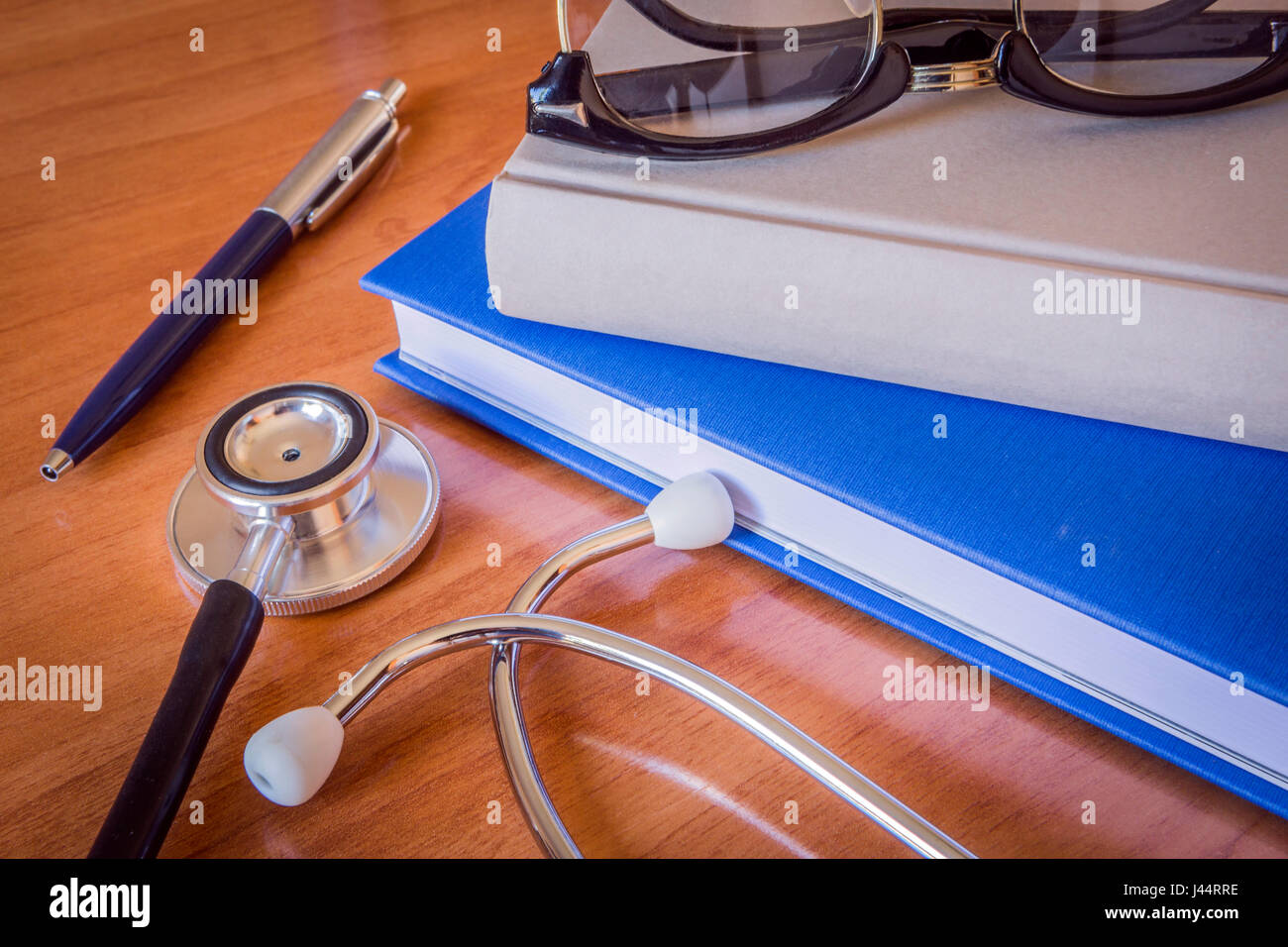 stethoscope and a book on brown background Stock Photo - Alamy