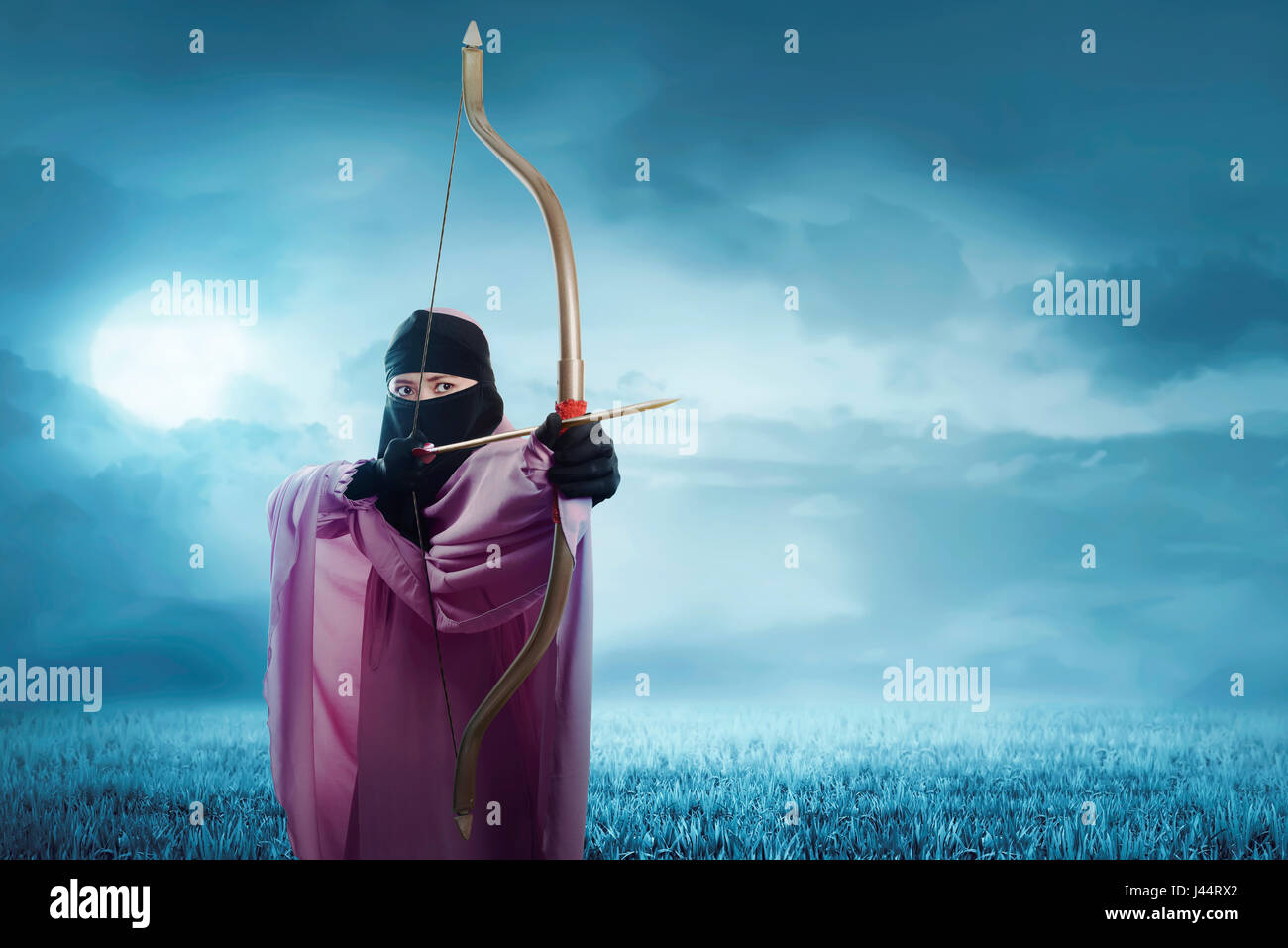 Beautiful woman aiming bow arrow hi-res stock photography and images ...