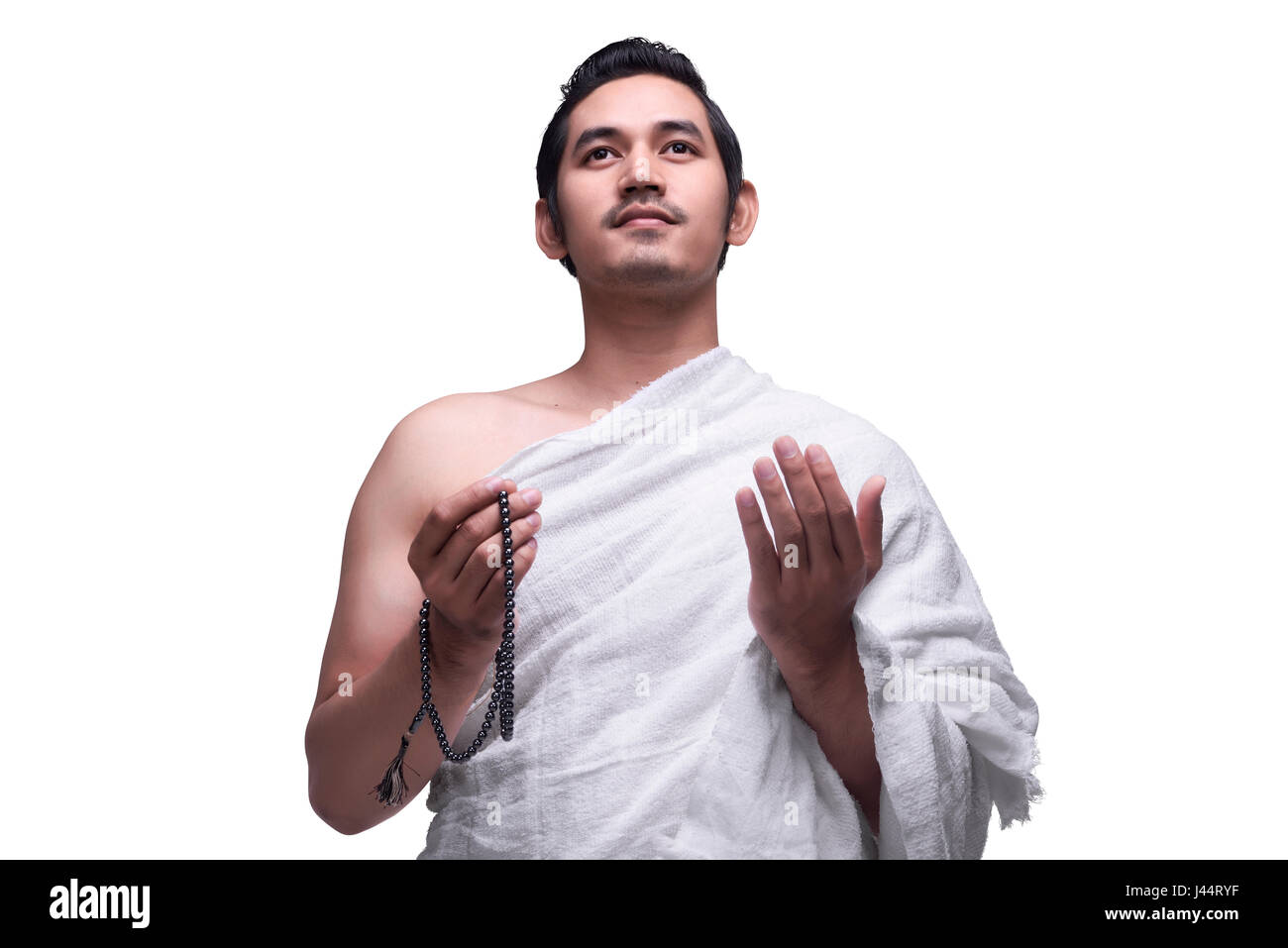 Religious asian muslim man in ihram dress ready for hajj isolated over ...
