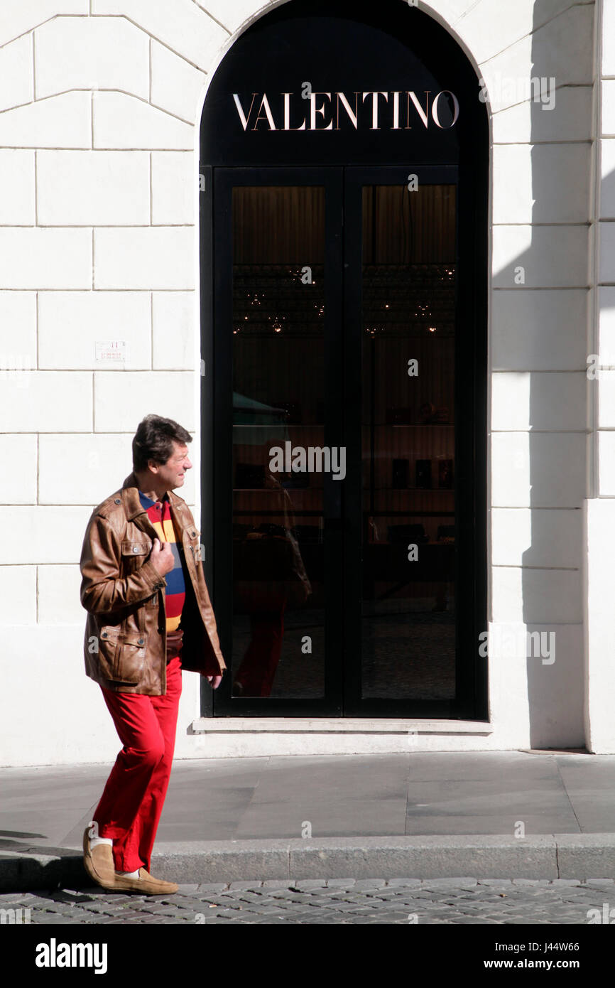 Pedestrian walk past of a Valentino store at Piazza Mignanelli, Rome ...
