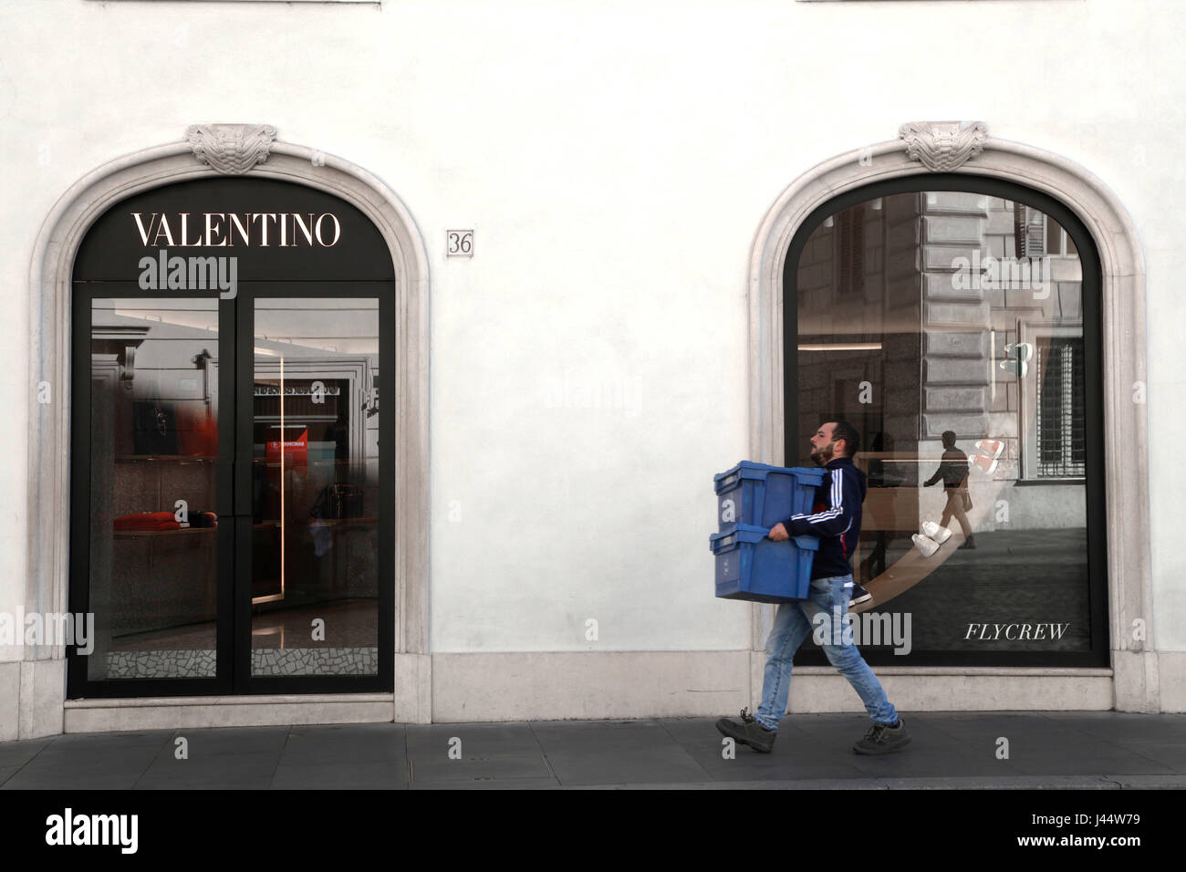 Pedestrian walk past of a Valentino store at Piazza Mignanelli, Rome ...