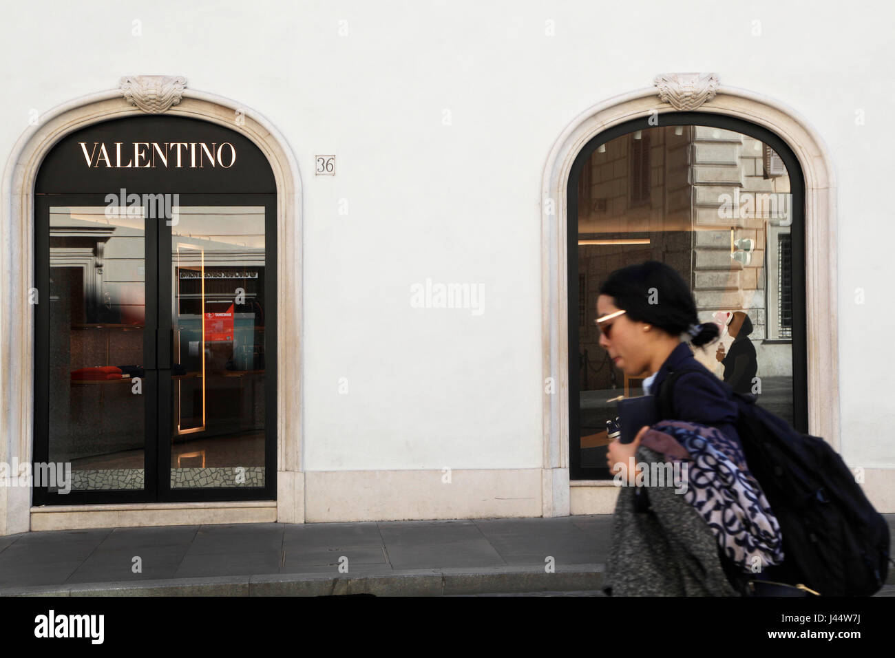 Pedestrian walk past of a Valentino store at Piazza Mignanelli, Rome ...