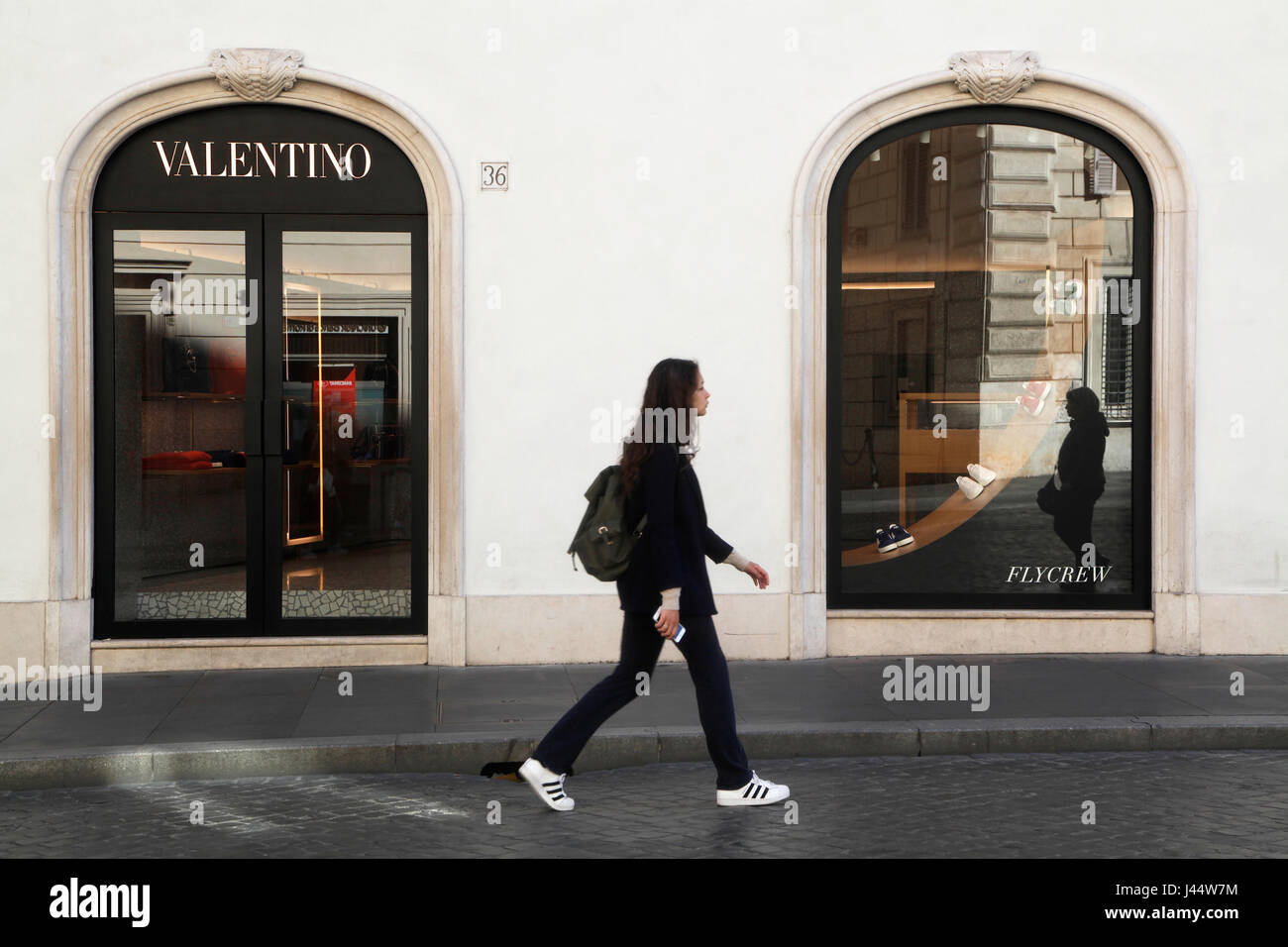 Pedestrian walk past of a Valentino store at Piazza Mignanelli, Rome ...