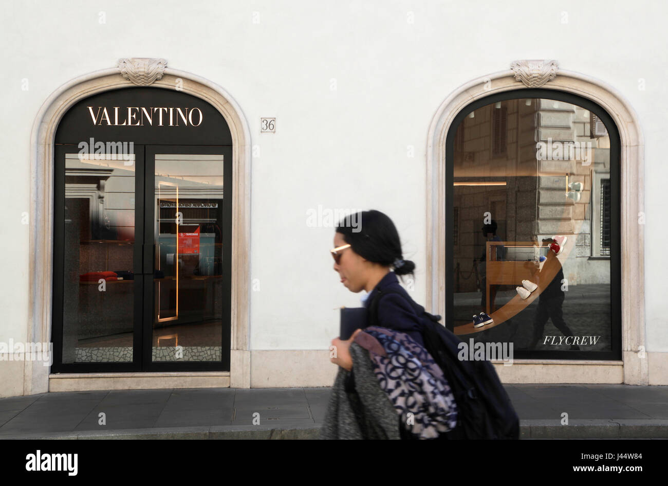 Pedestrian walk past of a Valentino store at Piazza Mignanelli, Rome ...