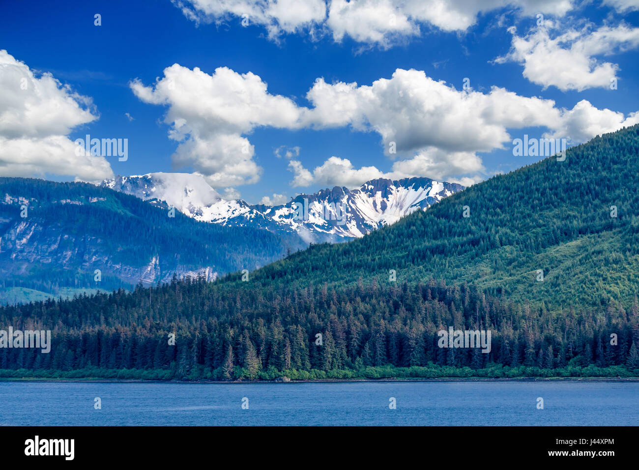 Alaska Green Hills and Blue Skies Over Blue Water Stock Photo - Alamy