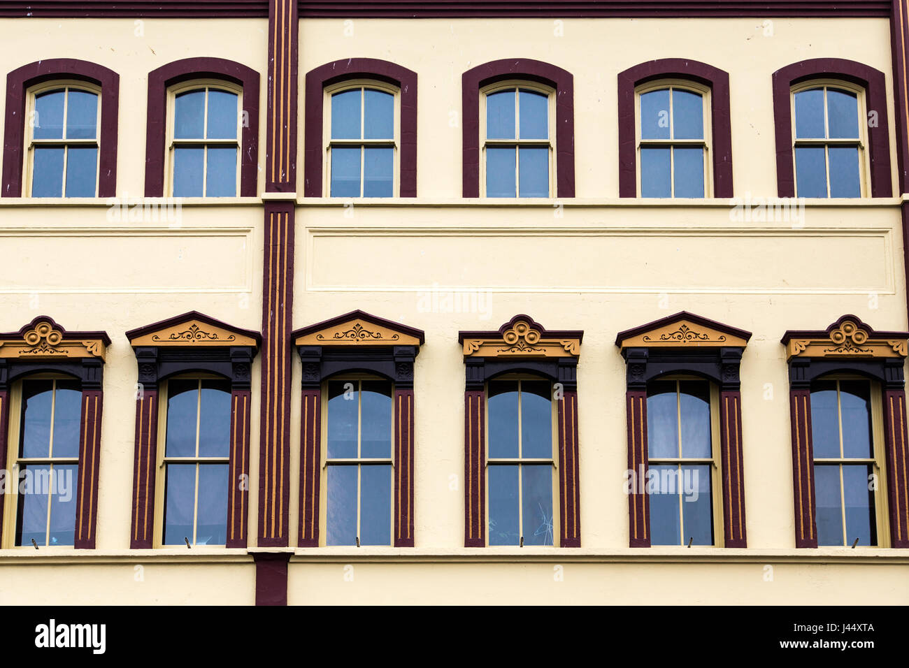 Blue Glass in Ornate Windows on Yellow Plaster Building Stock Photo - Alamy