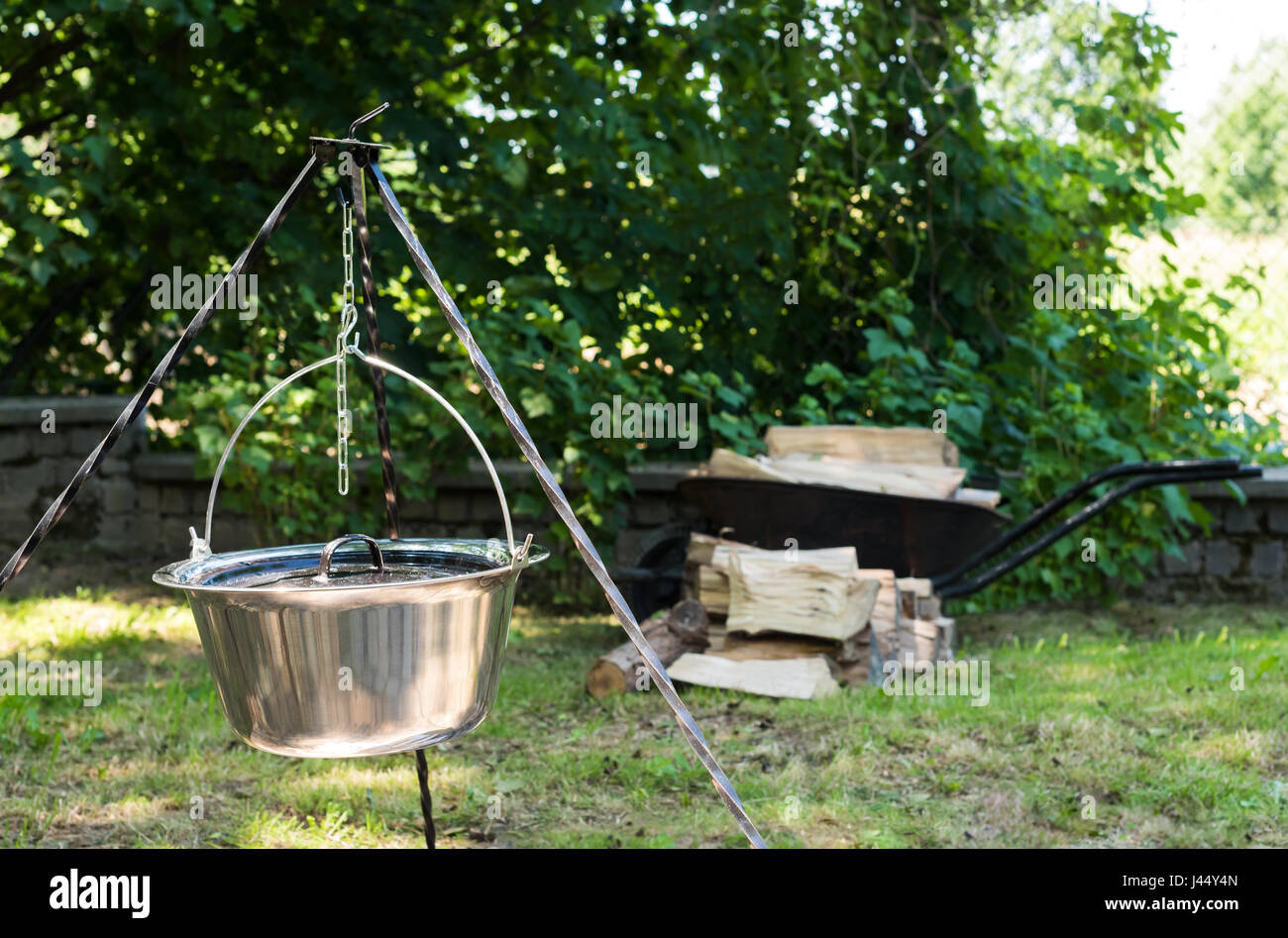 Cooking food on fire outdoors. Cooking outdoors in cast-iron cauldron ...