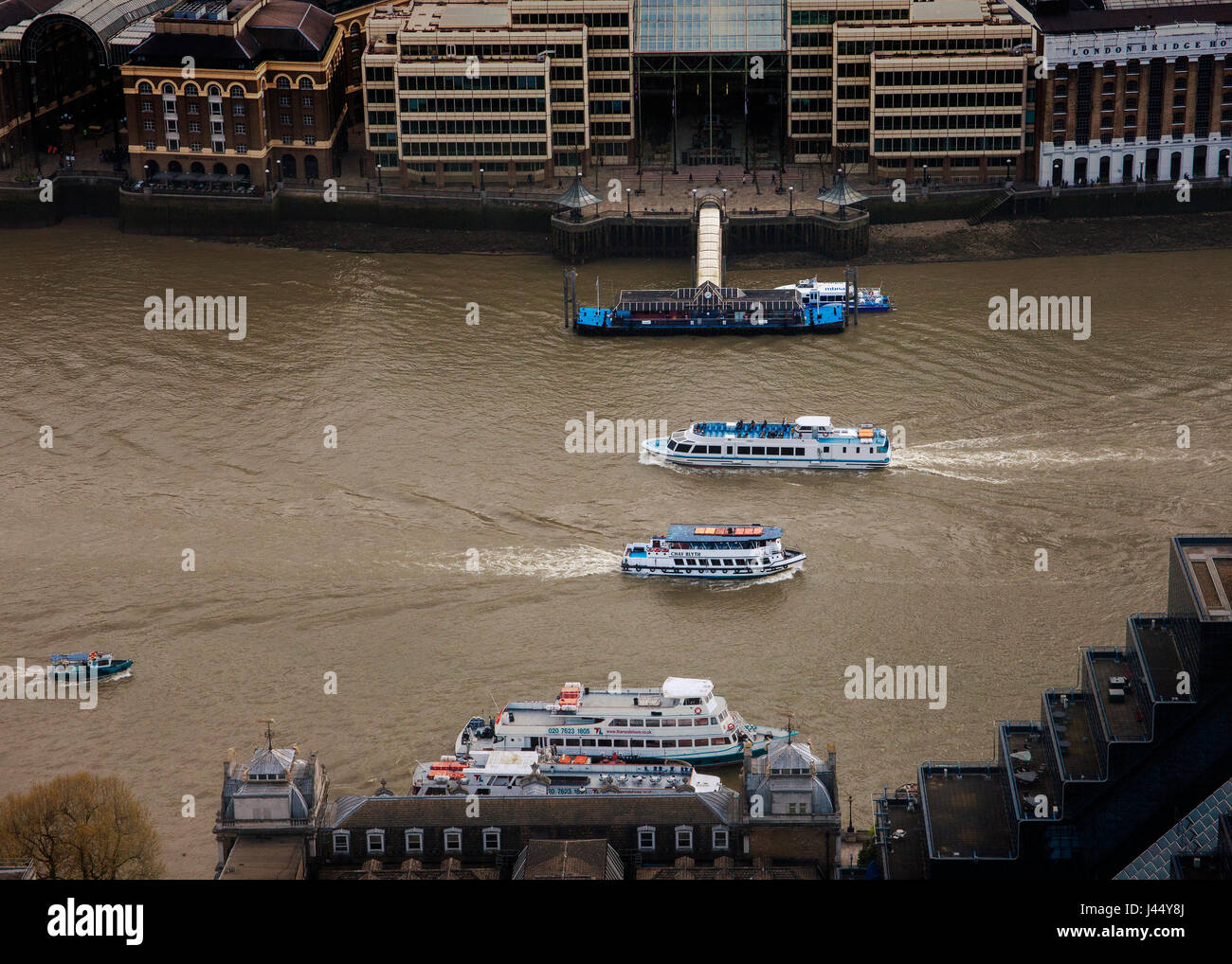 Thames clipper and tourist pleasure cruisers passing on Thames London ...