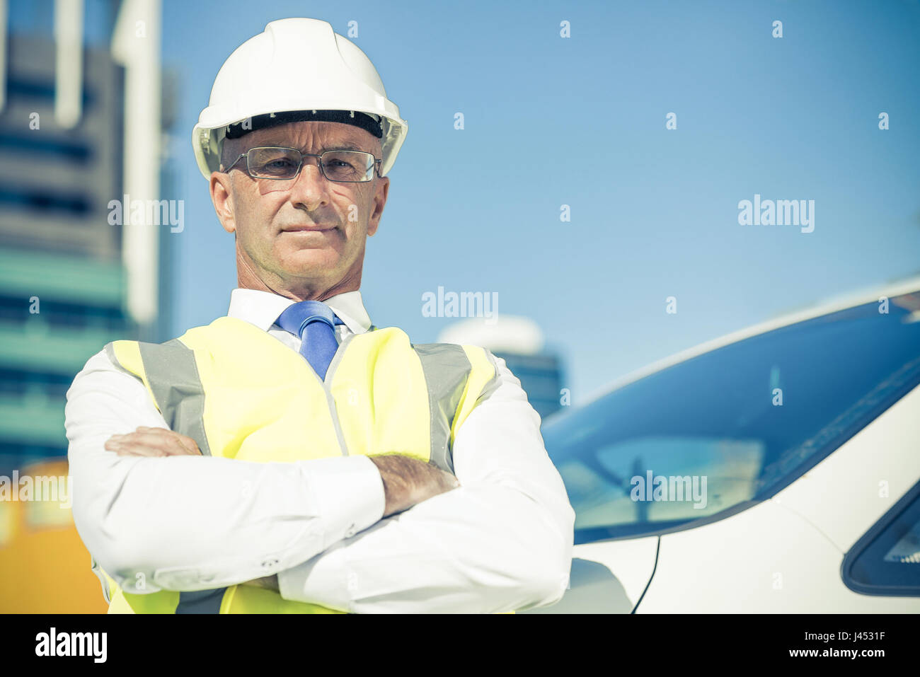 Senior builder man outdoors at construction site near his car lo Stock ...