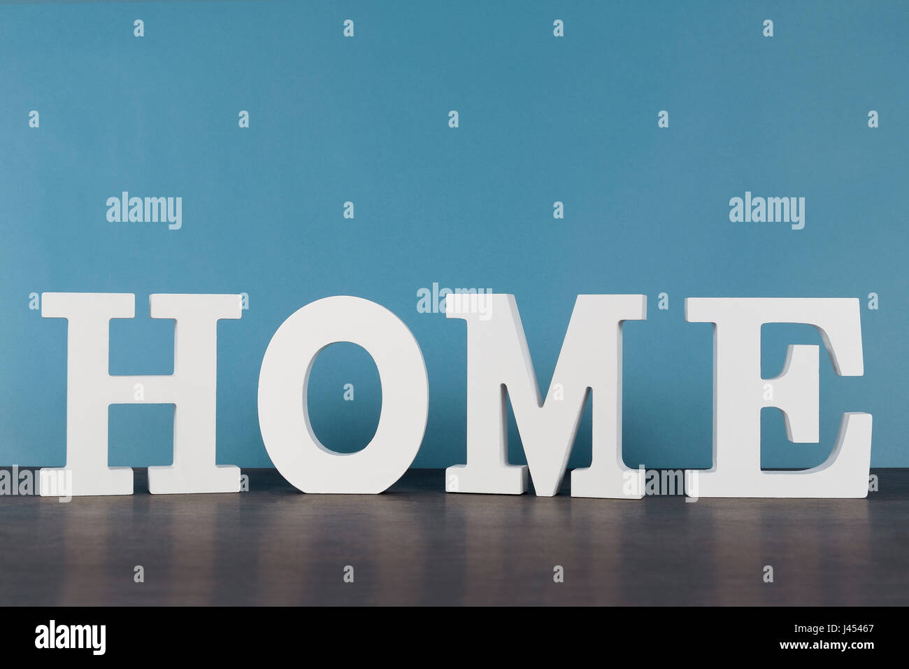 Home, written in letters, with blue wall paint Stock Photo - Alamy