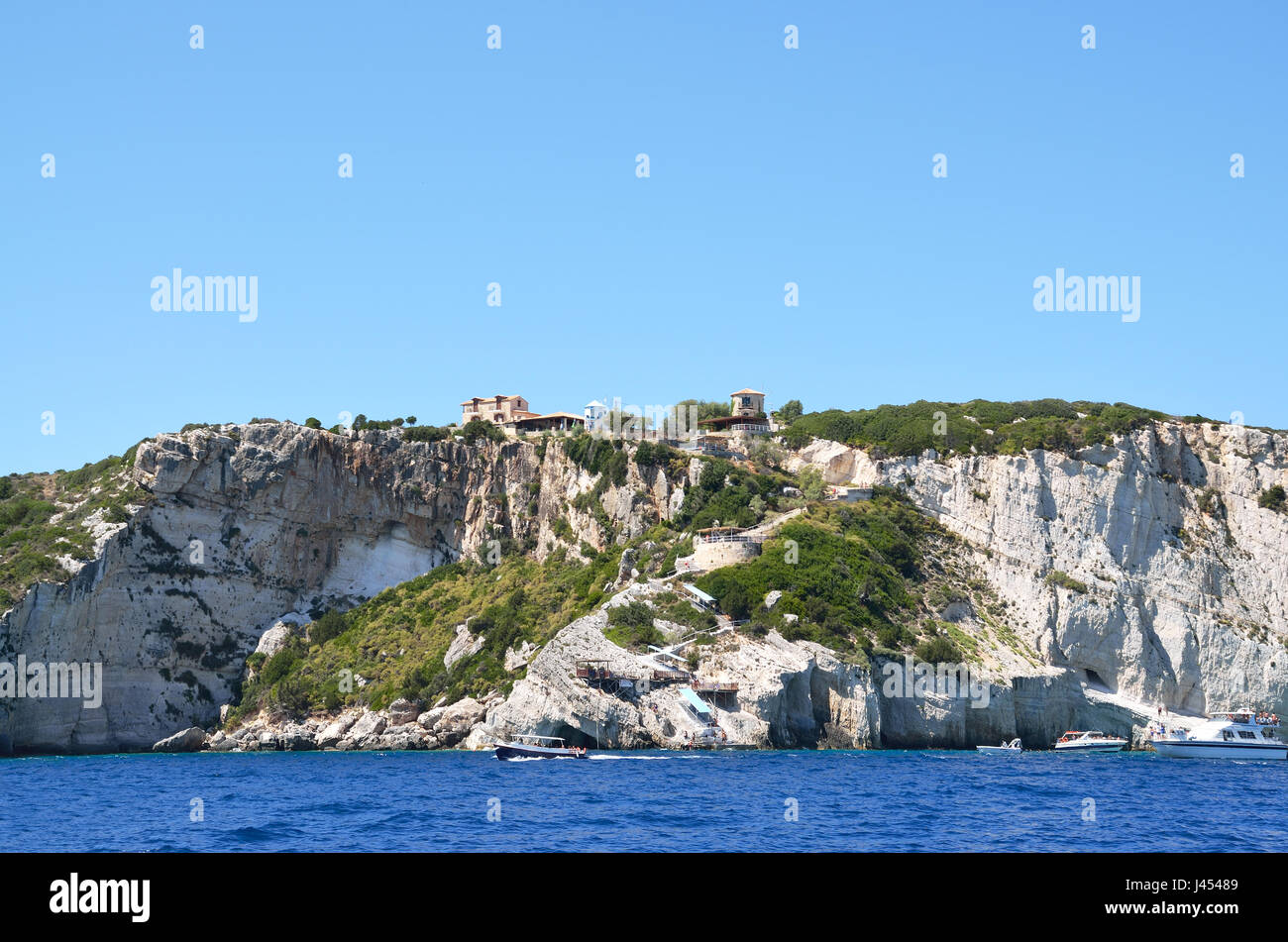 Windmills and lighthouse at Skinari in Zakynthos, Greece Stock Photo ...