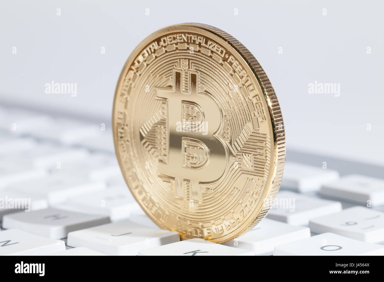 Bitcoin coin on keyboard Stock Photo - Alamy