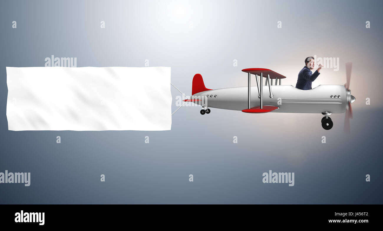 Biplane with businessman and blank banner Stock Photo - Alamy