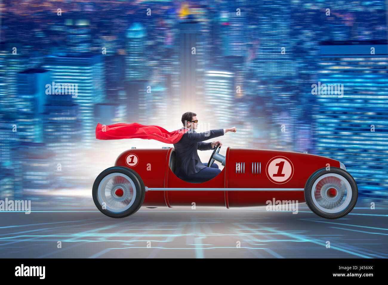 Superhero businessman driving vintage roadster Stock Photo - Alamy
