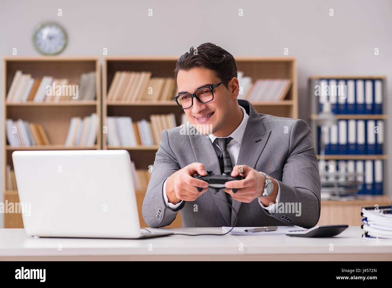 Businessman playing computer games at work office Stock Photo - Alamy