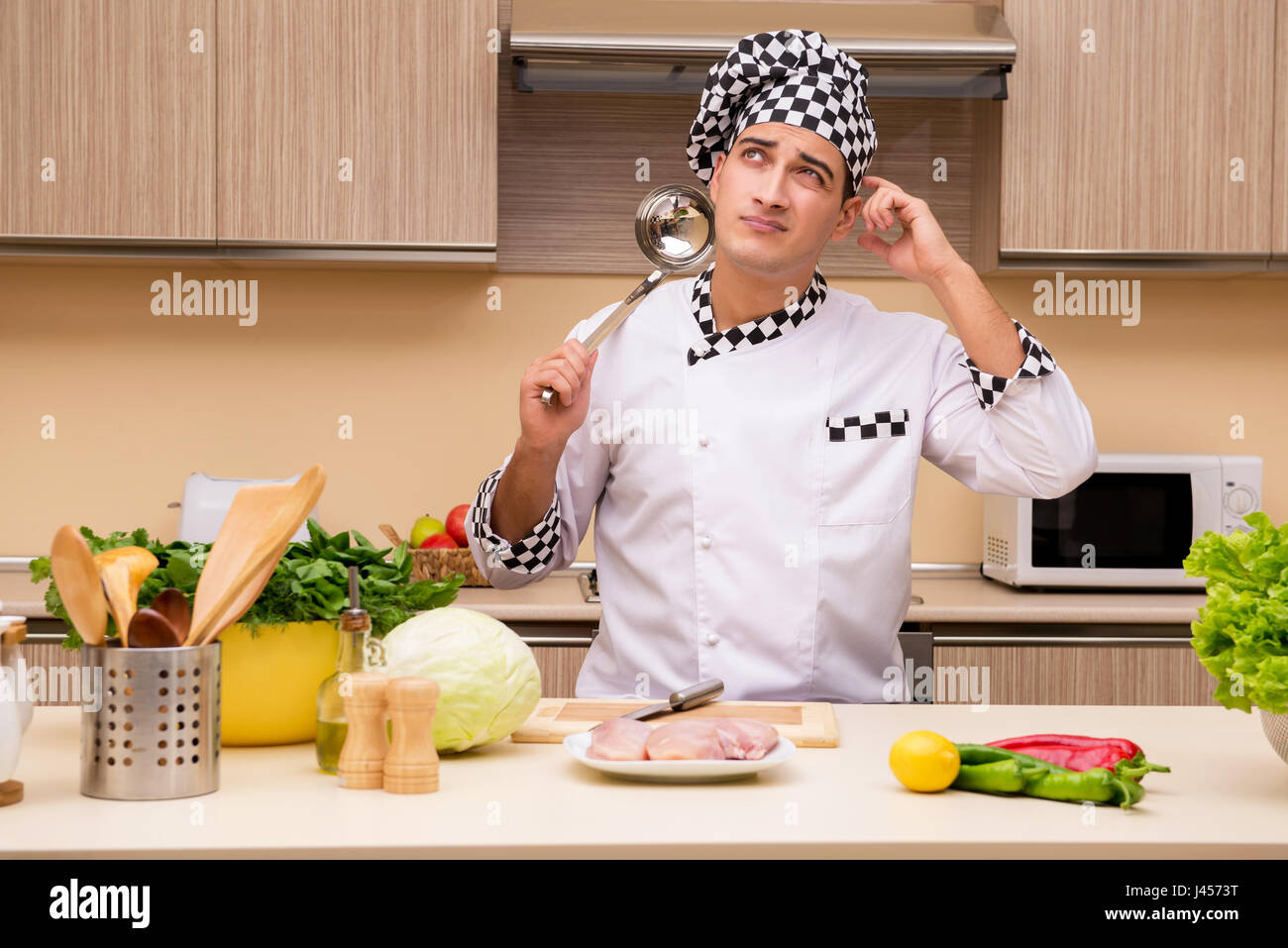 Young chef working in the kitchen Stock Photo - Alamy