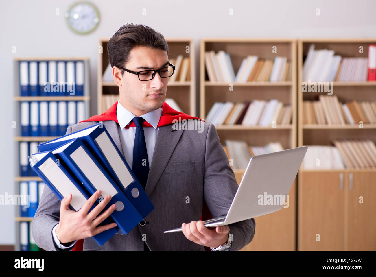 Superhero businessman working in the office Stock Photo - Alamy