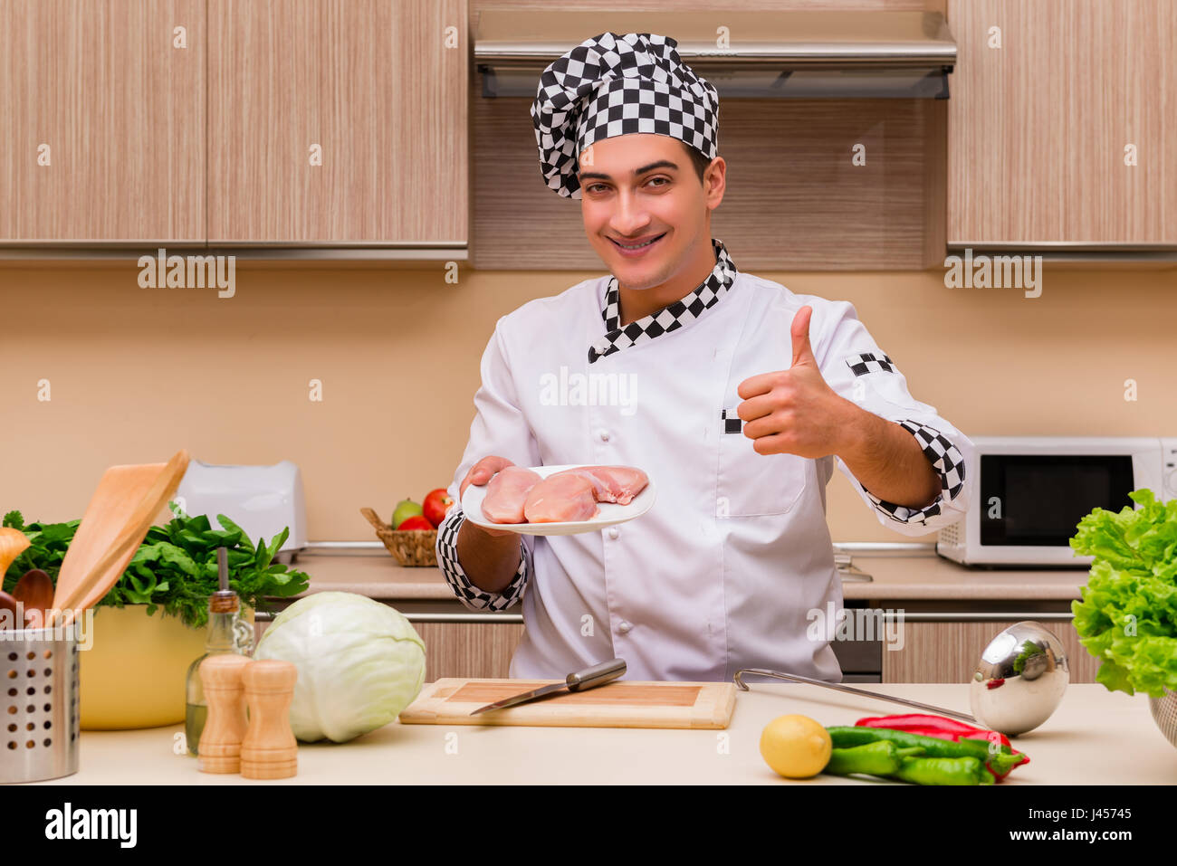 Young chef working in the kitchen Stock Photo - Alamy