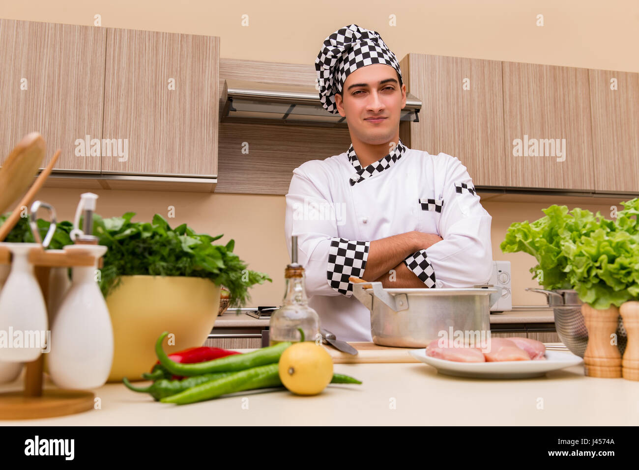 Young chef working in the kitchen Stock Photo - Alamy