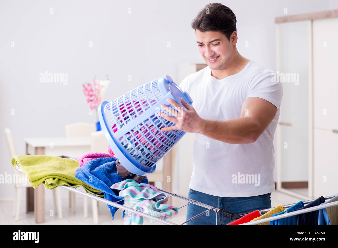 Man doing laundry at home Stock Photo - Alamy