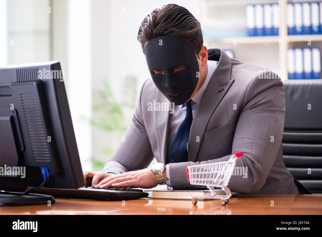 Businessman with mask in office hypocrisy concept Stock Photo - Alamy