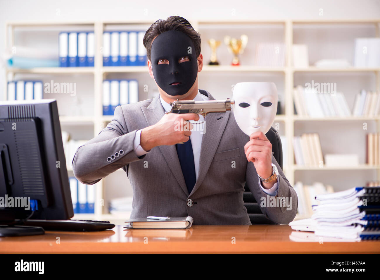 Businessman with mask in office hypocrisy concept Stock Photo - Alamy