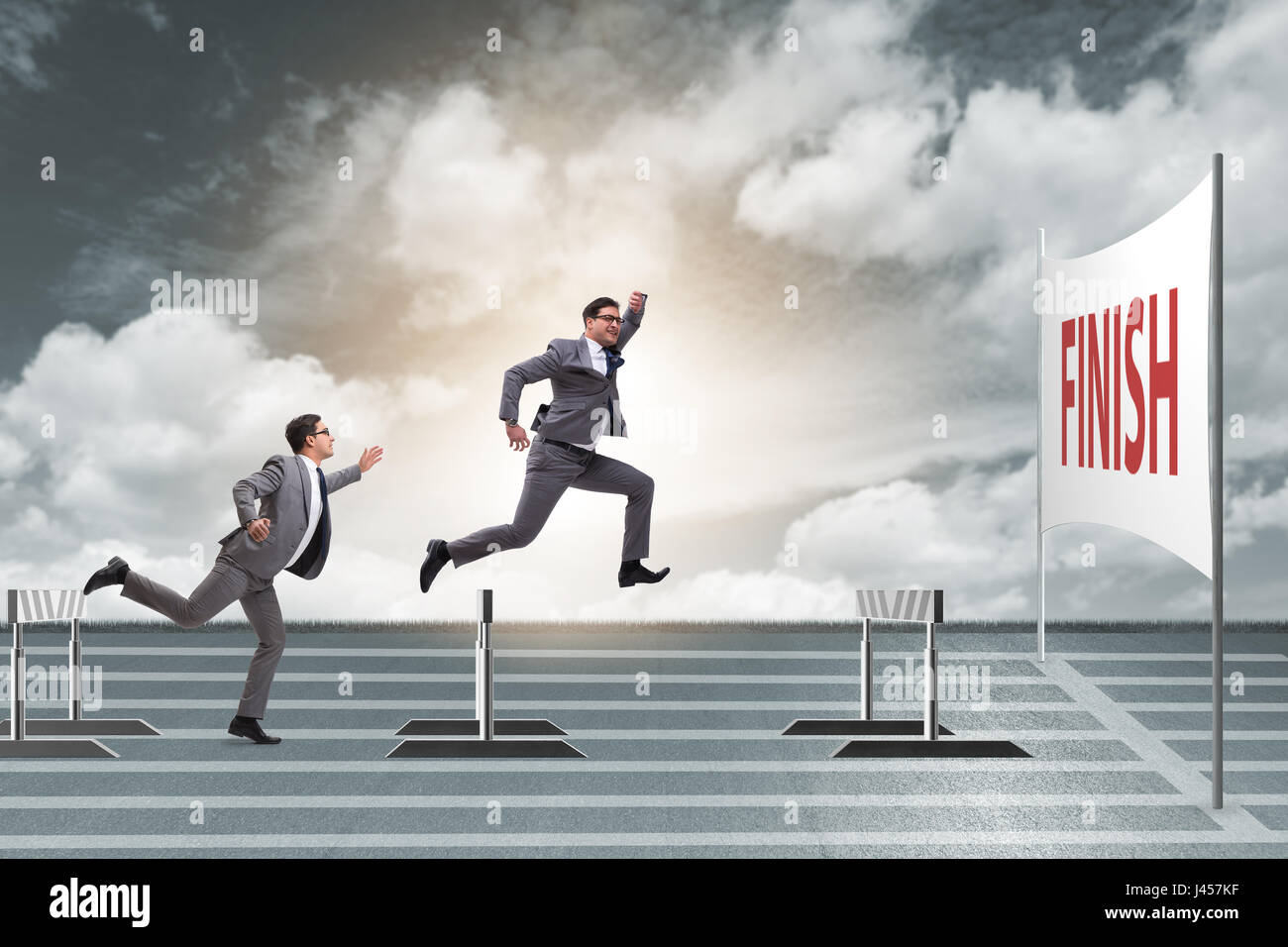 Businessman jumping over barriers in business concept Stock Photo - Alamy