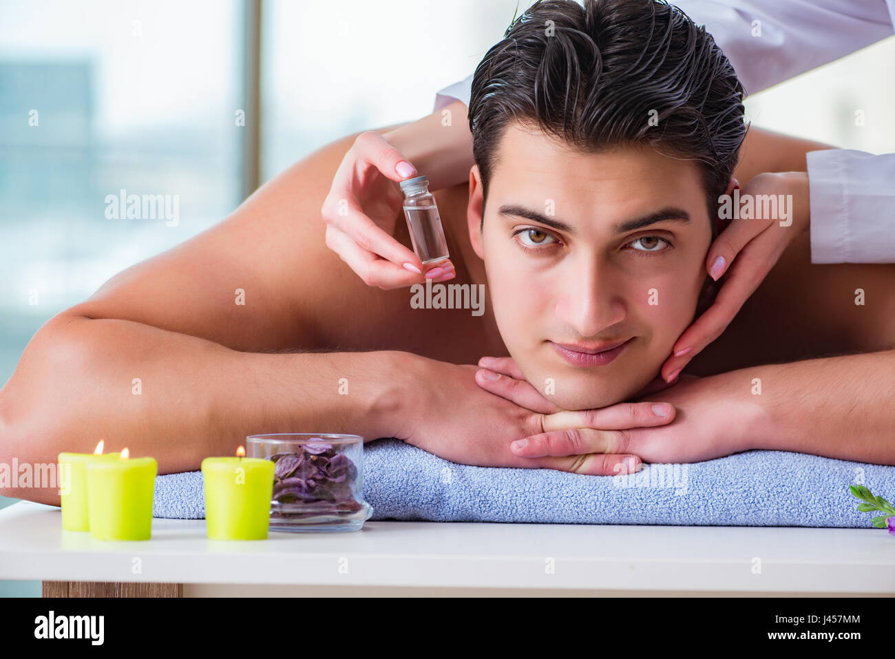 Handsome man in spa massage concept Stock Photo - Alamy
