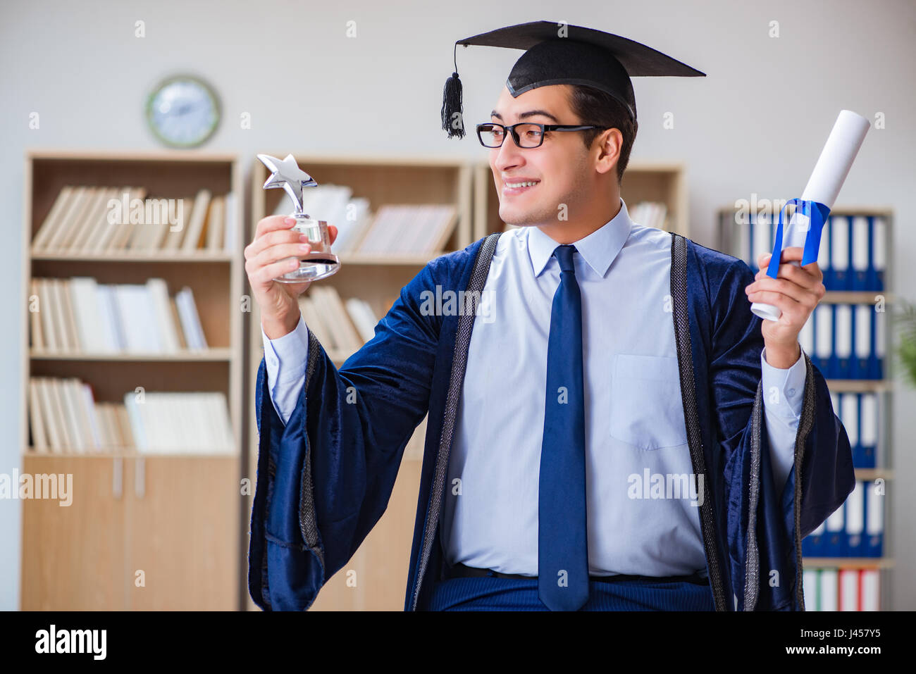 Young man graduating from university Stock Photo - Alamy