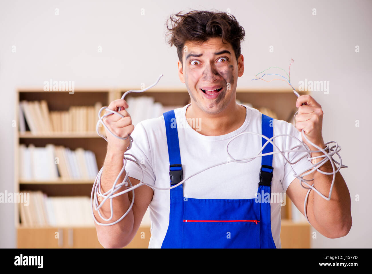 Funny Man doing electrical repairs at home Stock Photo - Alamy