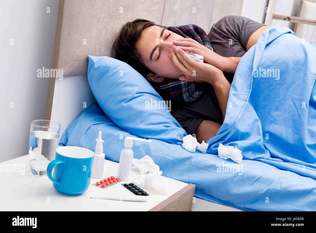 Sick ill man in the bed taking medicines and drugs Stock Photo - Alamy