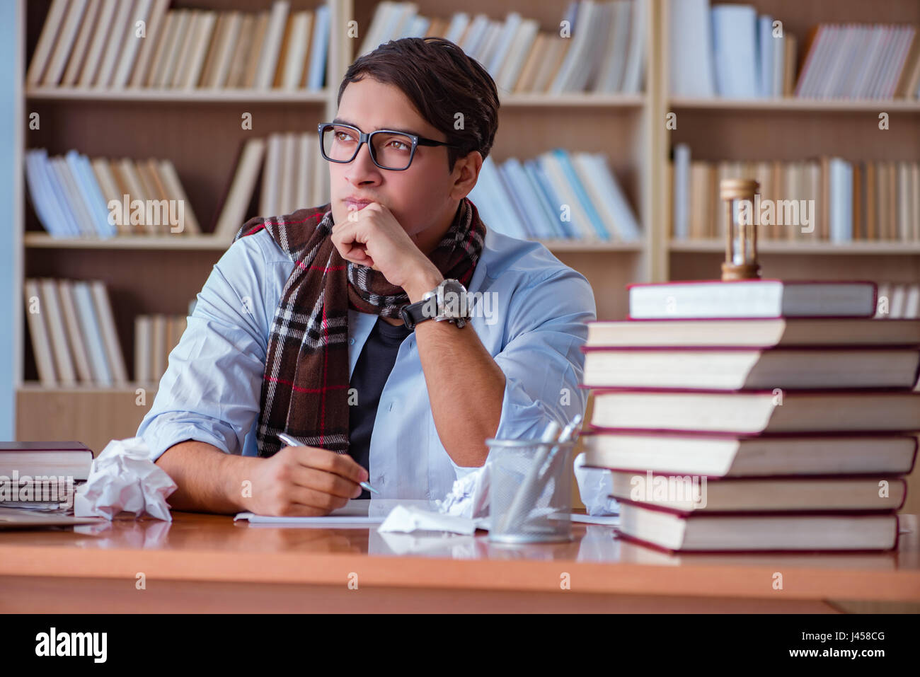 Young book writer writing in library Stock Photo - Alamy