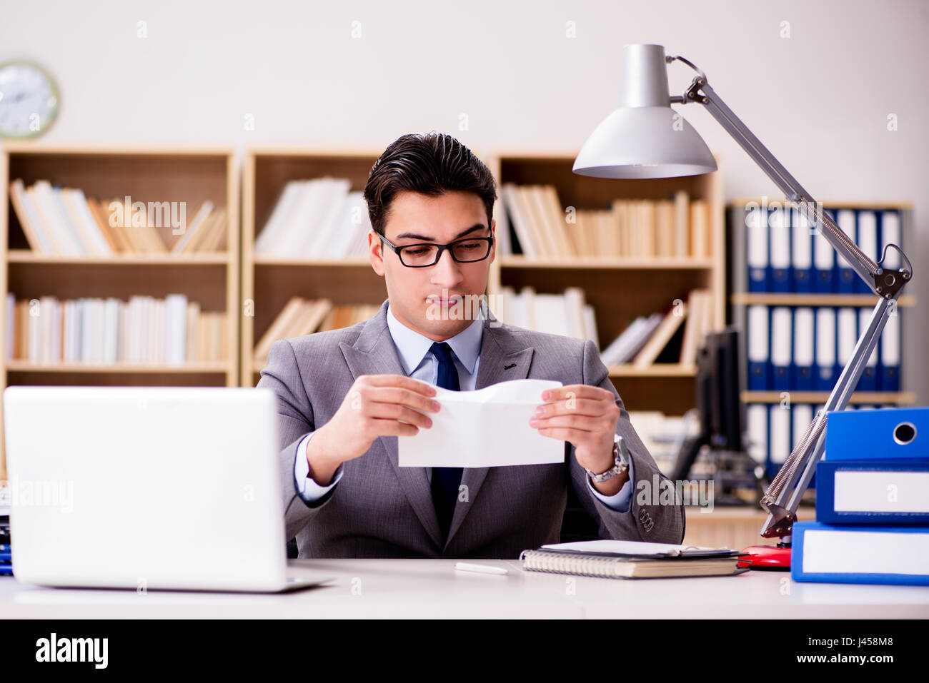 Businessman receiving letter envelope in office Stock Photo - Alamy