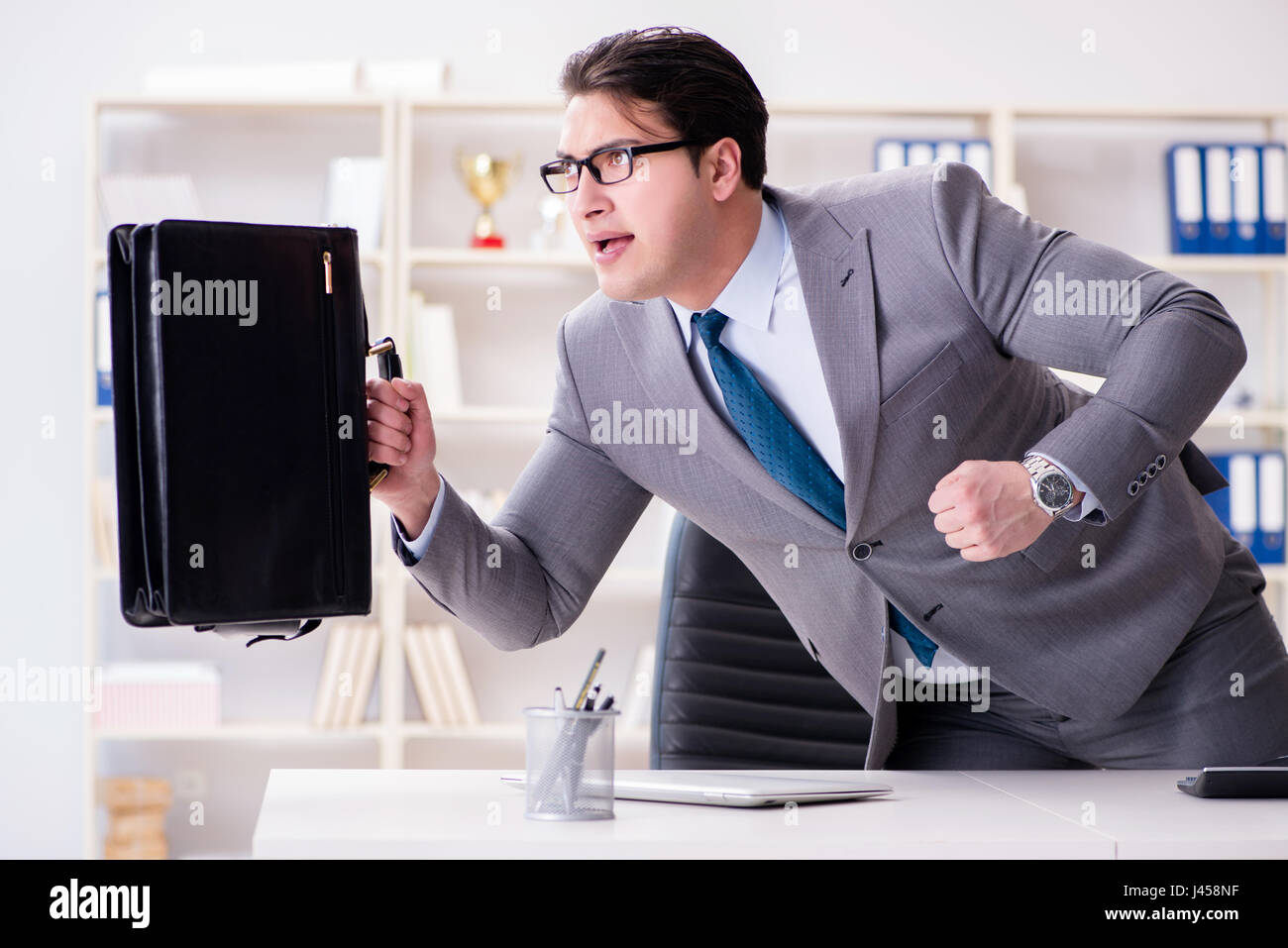 Businessman rushing in the office Stock Photo - Alamy