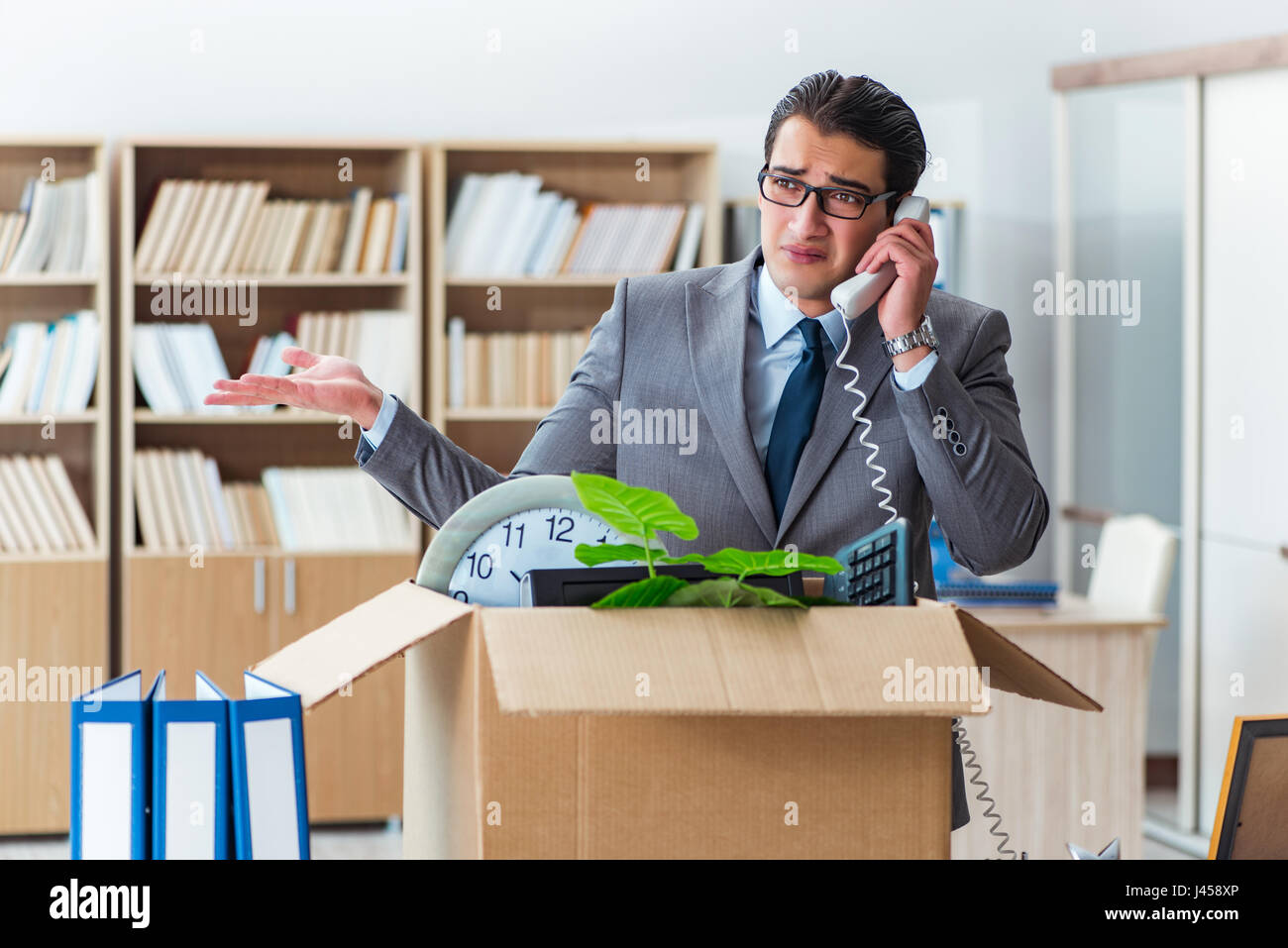 Man moving office with box and his belongings Stock Photo - Alamy