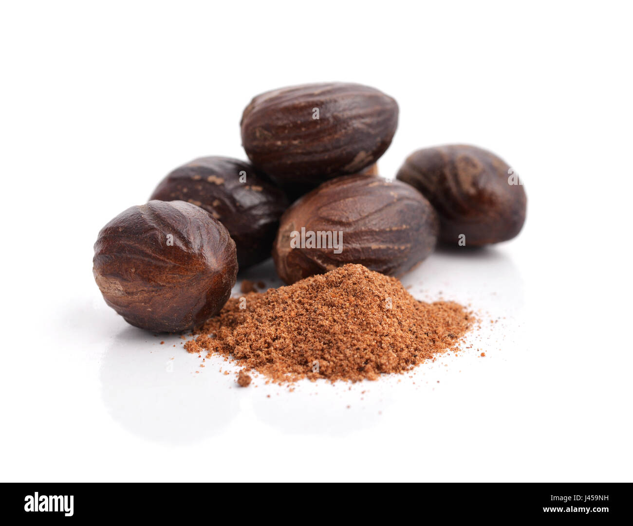 Group of nutmegs (seeds of Myristica fragrans), whole and ground ...