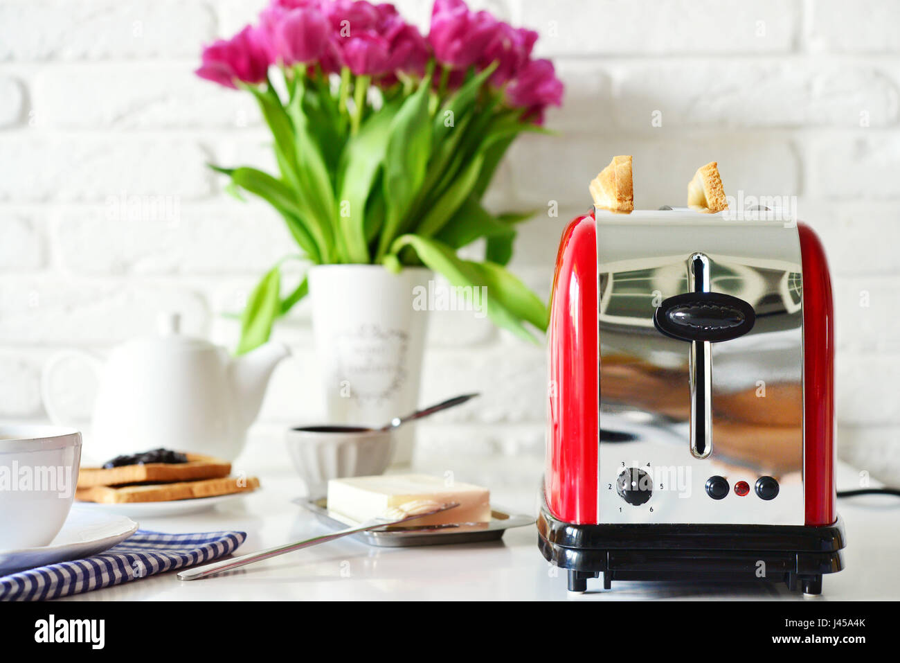Toaster with bread in kitchen interior closeup Stock Photo - Alamy