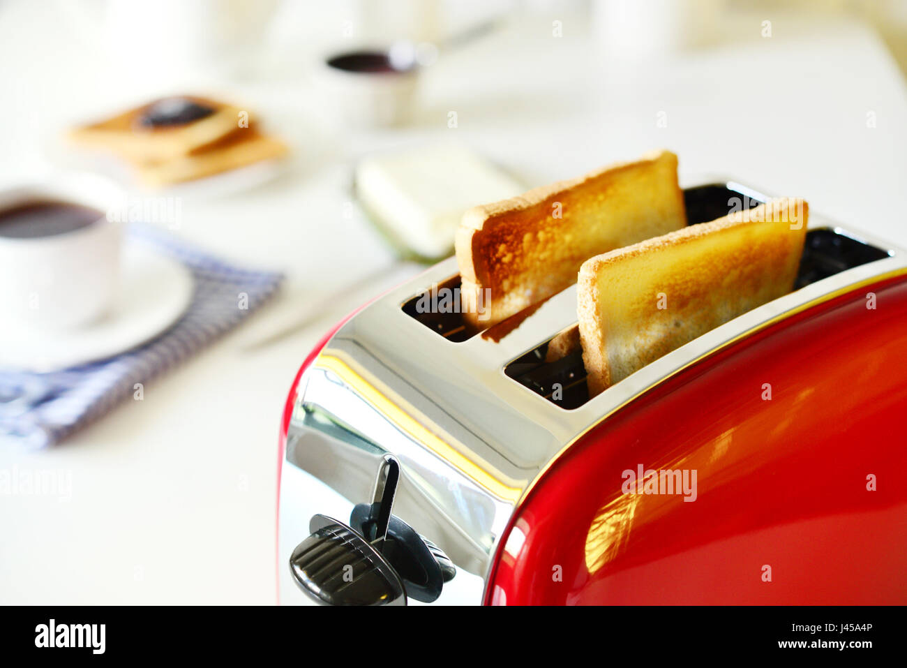 Toaster with bread in kitchen interior closeup Stock Photo - Alamy