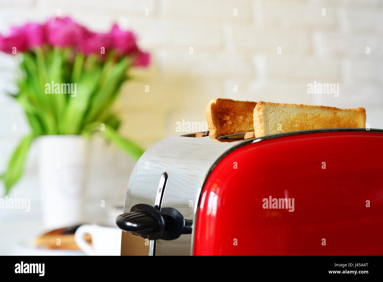 Toaster with bread in kitchen interior closeup Stock Photo - Alamy