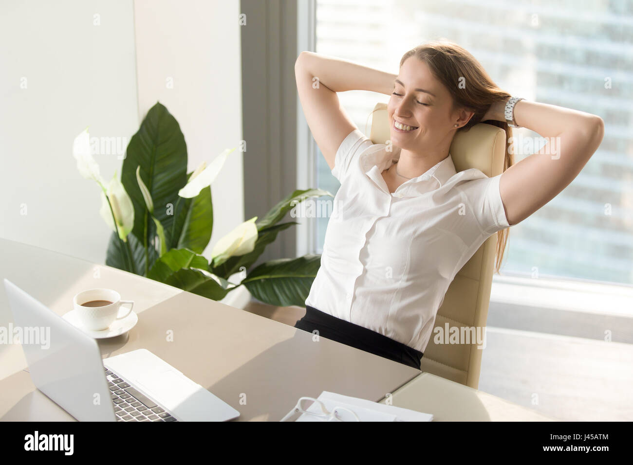 Businesswoman having positive feelings about work Stock Photo - Alamy