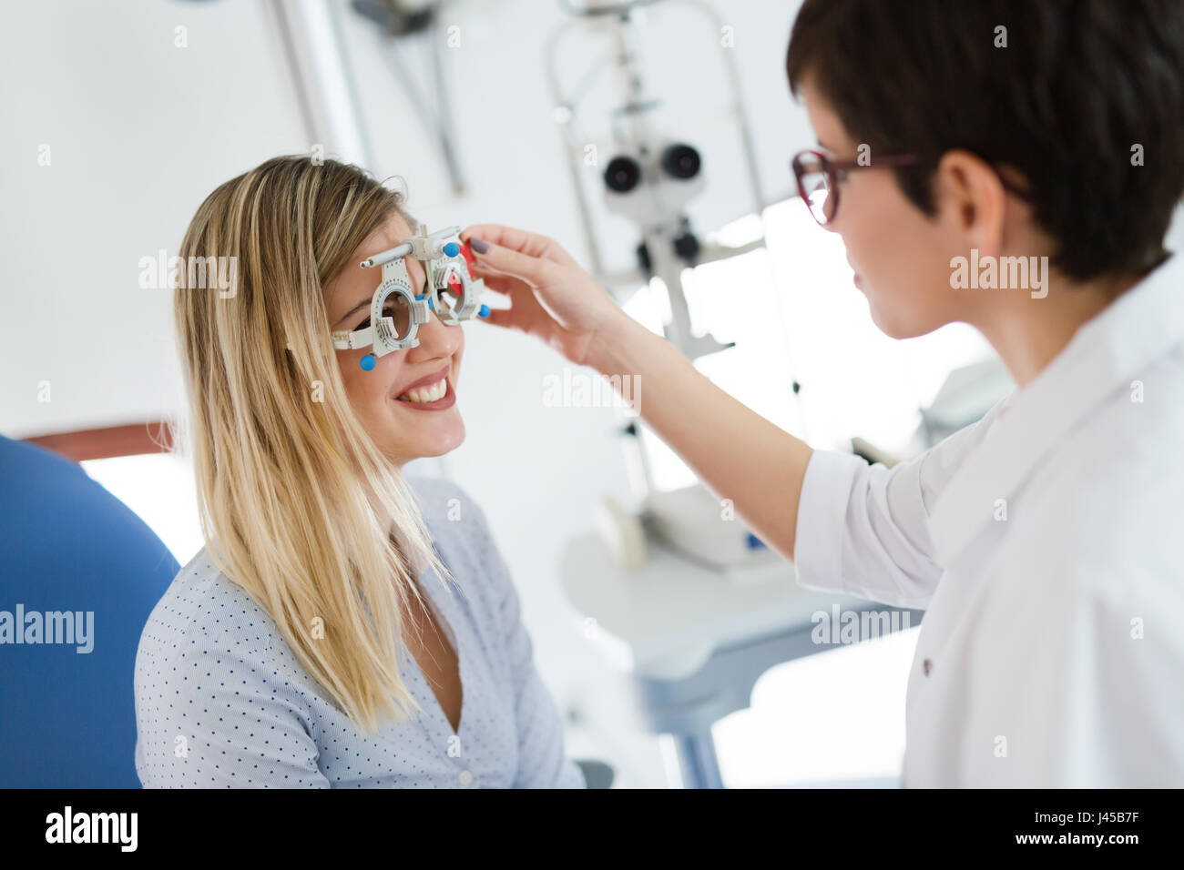 optometrist checking patient eyesight and suggesting vision correction ...