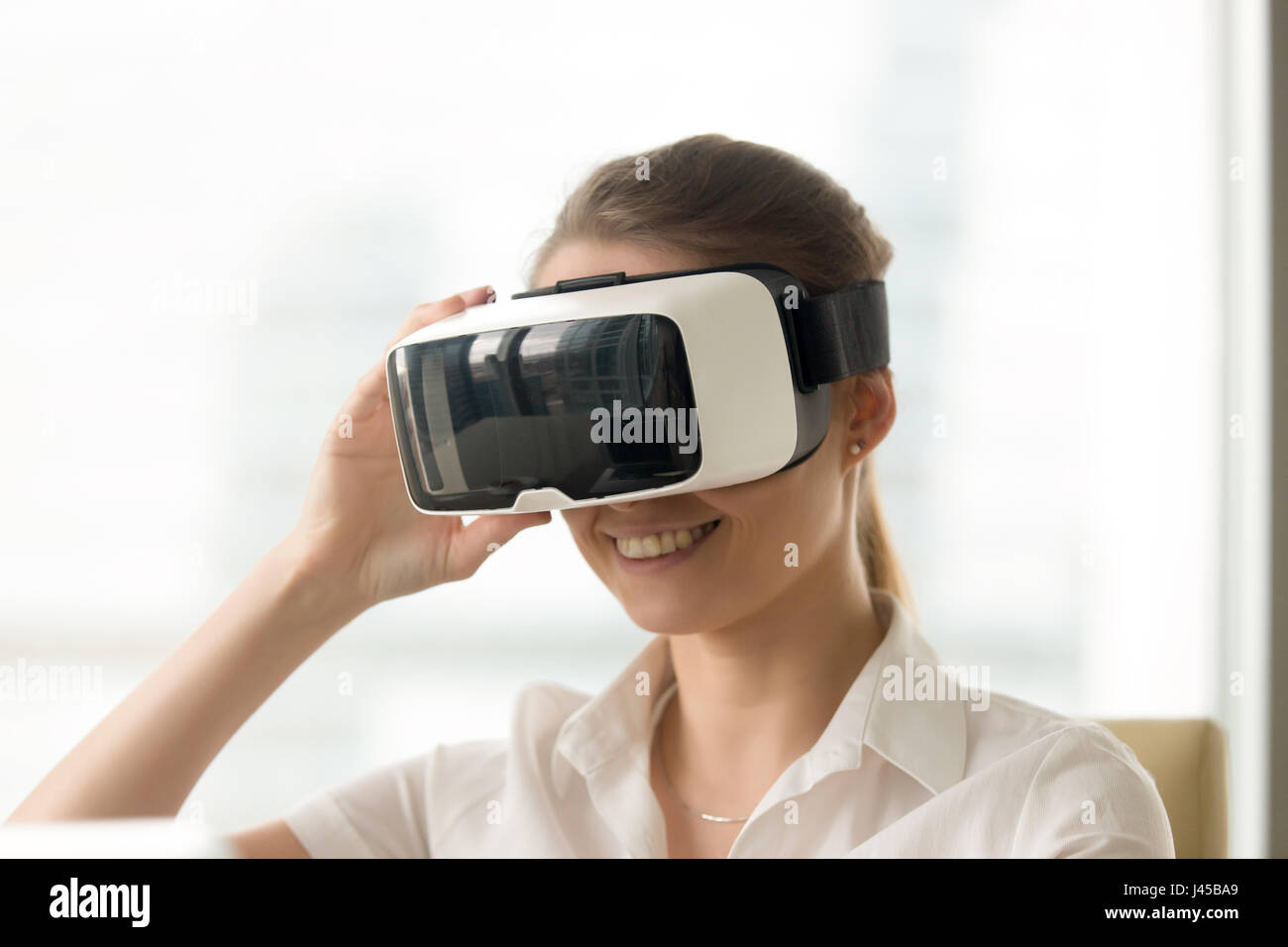 Smiling girl in vr glasses hi-res stock photography and images - Alamy