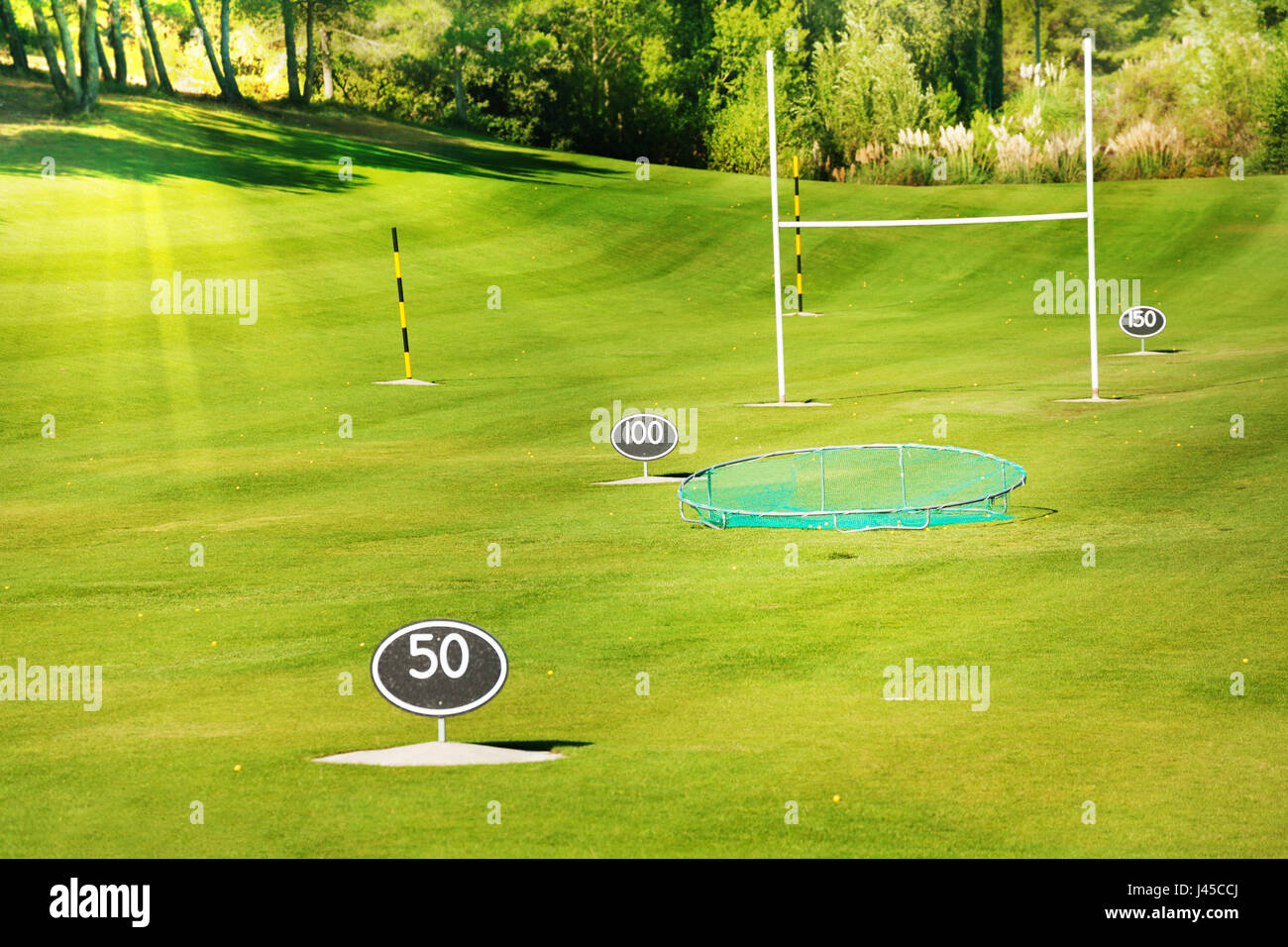 Driving range at golf course with yard signs Stock Photo - Alamy