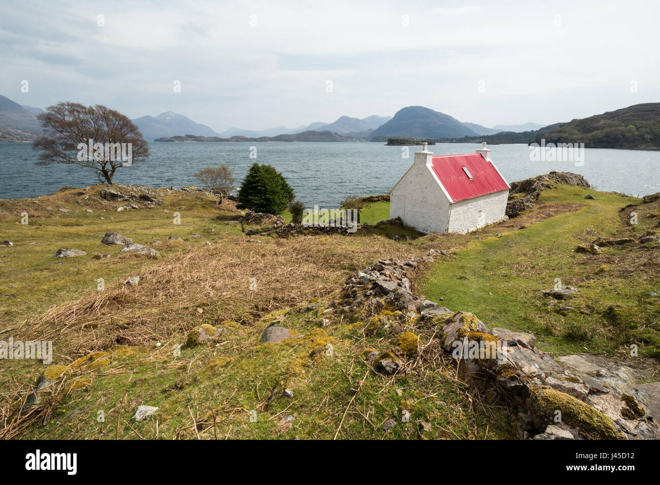 red roofed whitewashed cottage house overlooking Loch Shieldaig, near ...