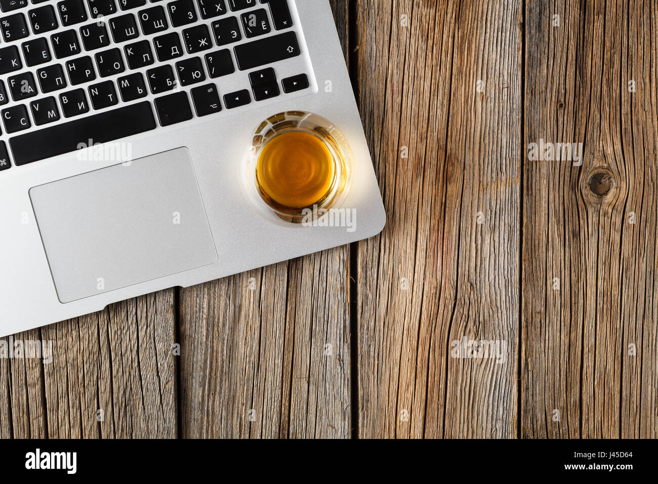 whiskey glass on laptop Stock Photo - Alamy