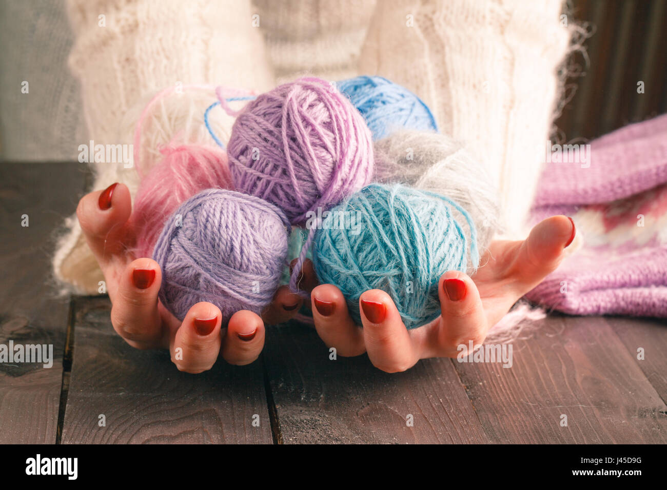 Hands holding a balls of yarn Stock Photo - Alamy